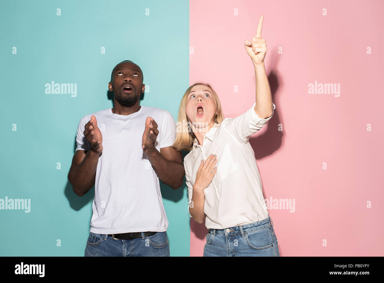 Portrait of the scared man and woman on pink and blue Stock Photo - Alamy