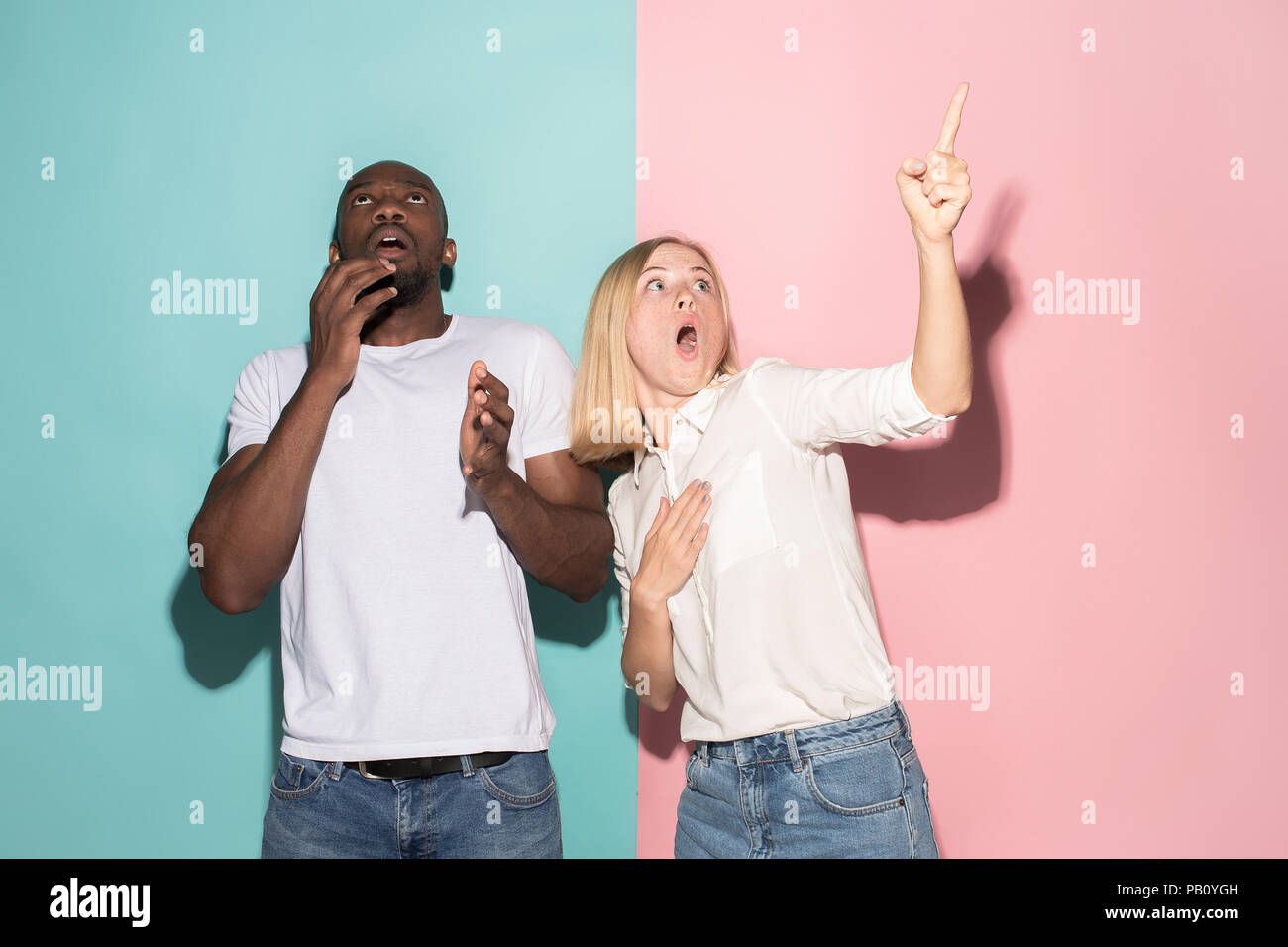 Portrait of the scared man and woman on pink and blue Stock Photo - Alamy