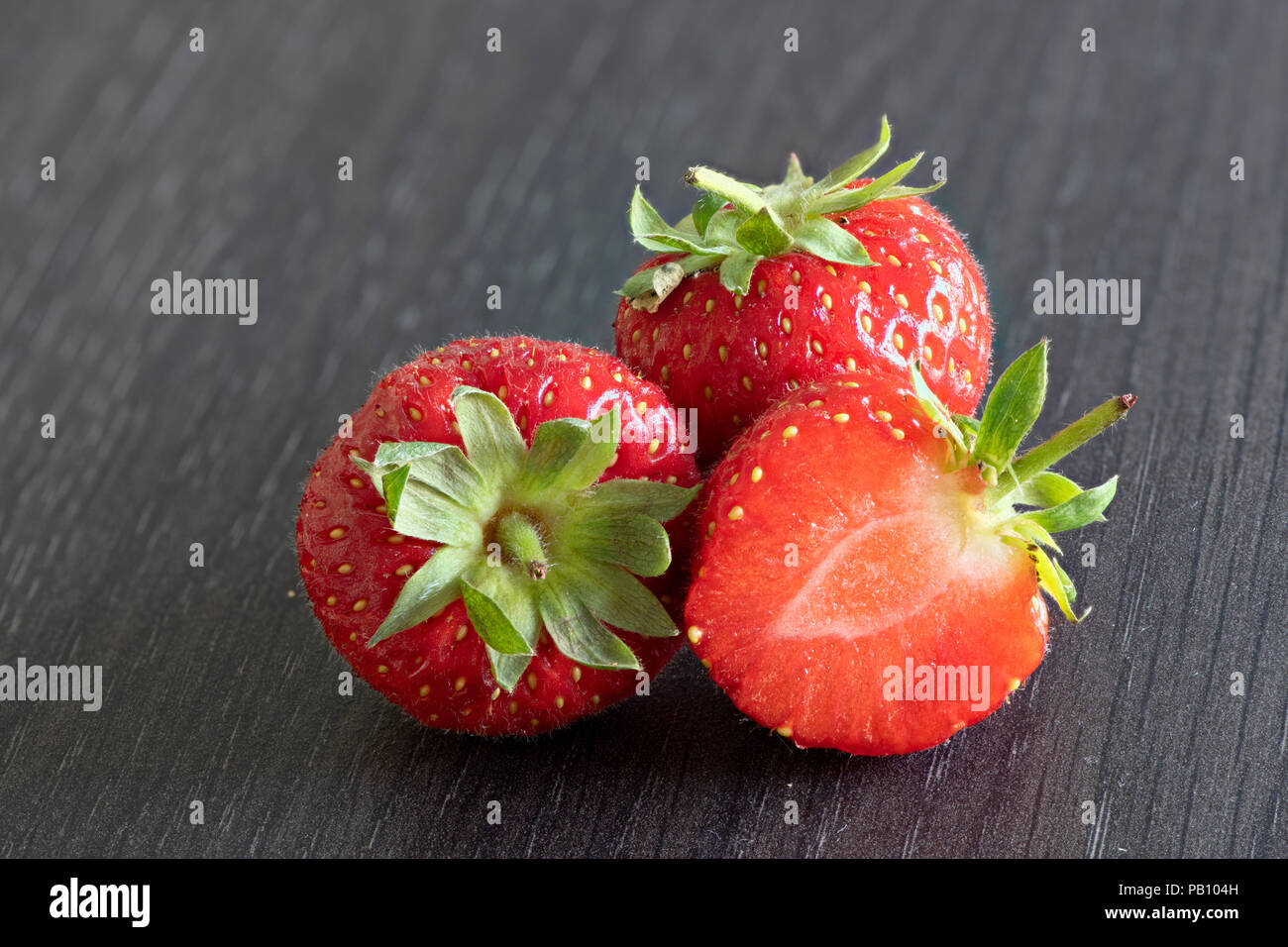 Luscious ripe fresh strawberries on a grey kitchen worktop. One ...