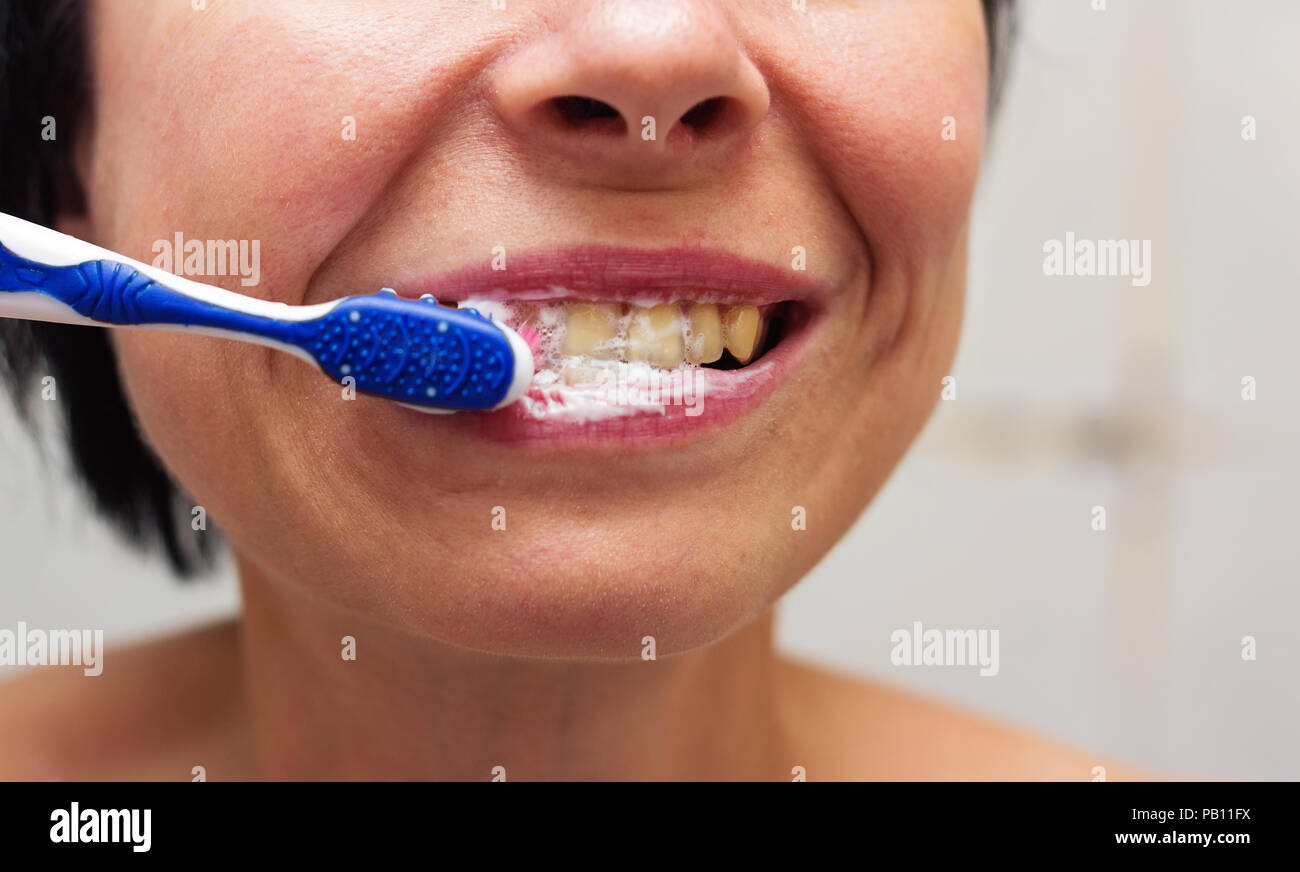 A woman is cleaning teeth with a toothbrush with toothpaste Stock Photo ...