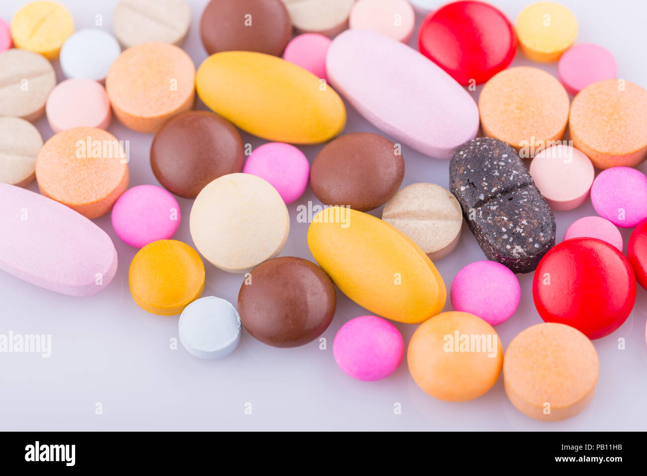 Tablets pills capsule heap mix therapy drugs, over a white background ...