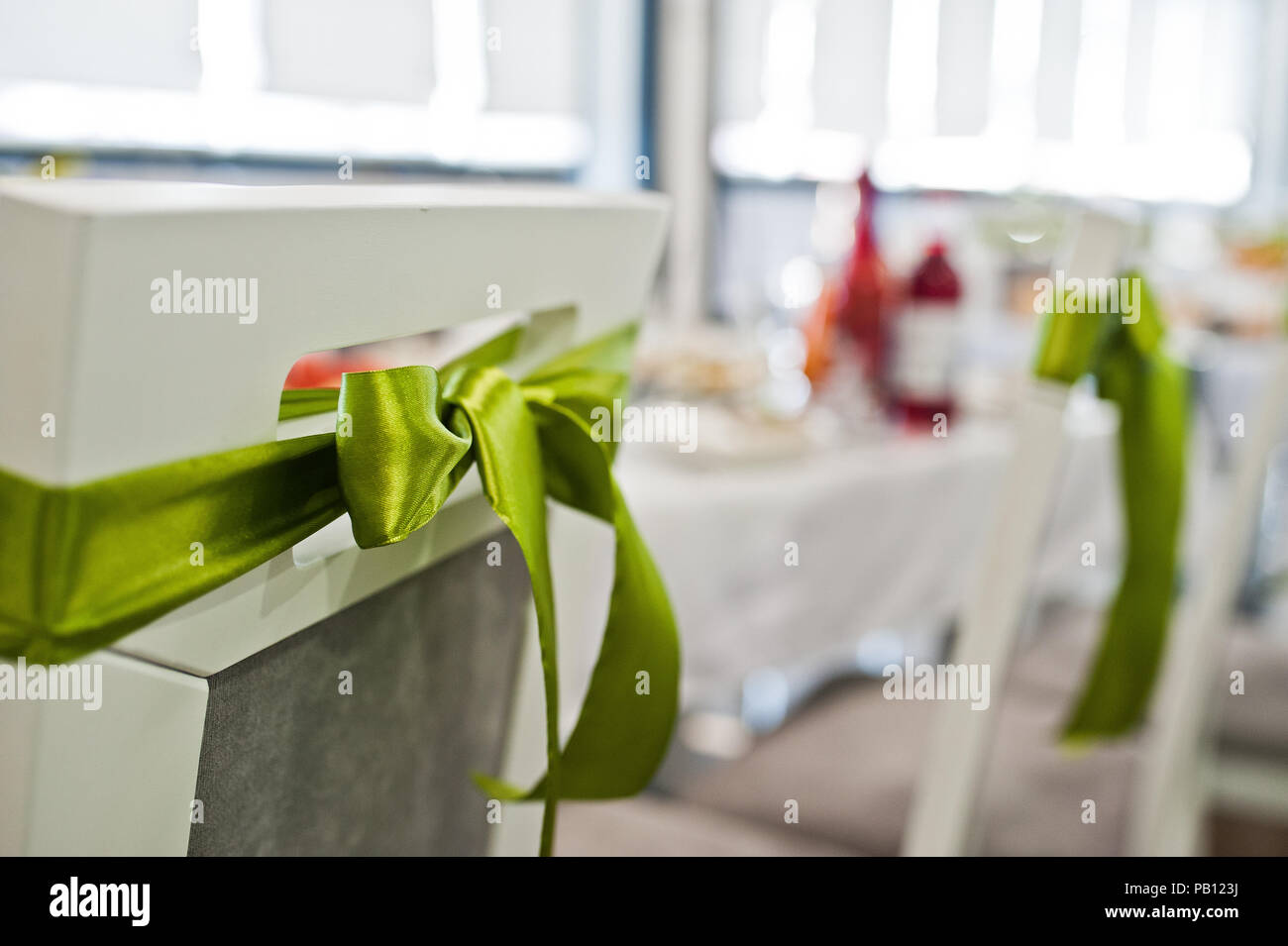 Close-up photo of a tied green ribbon on the chair Stock Photo - Alamy