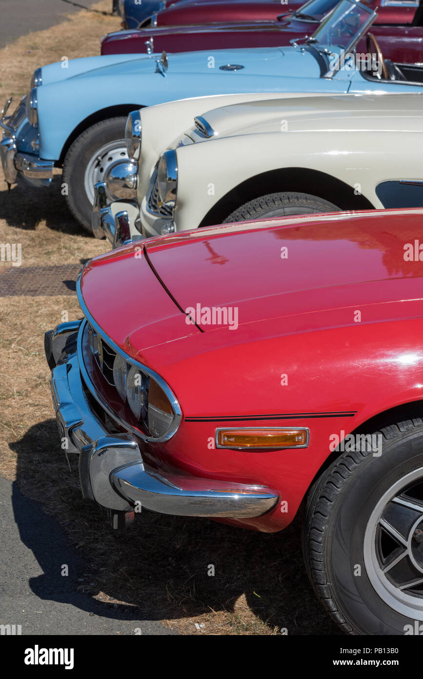 o row or line of vintage traditional classic car bonnets and bumpers ...