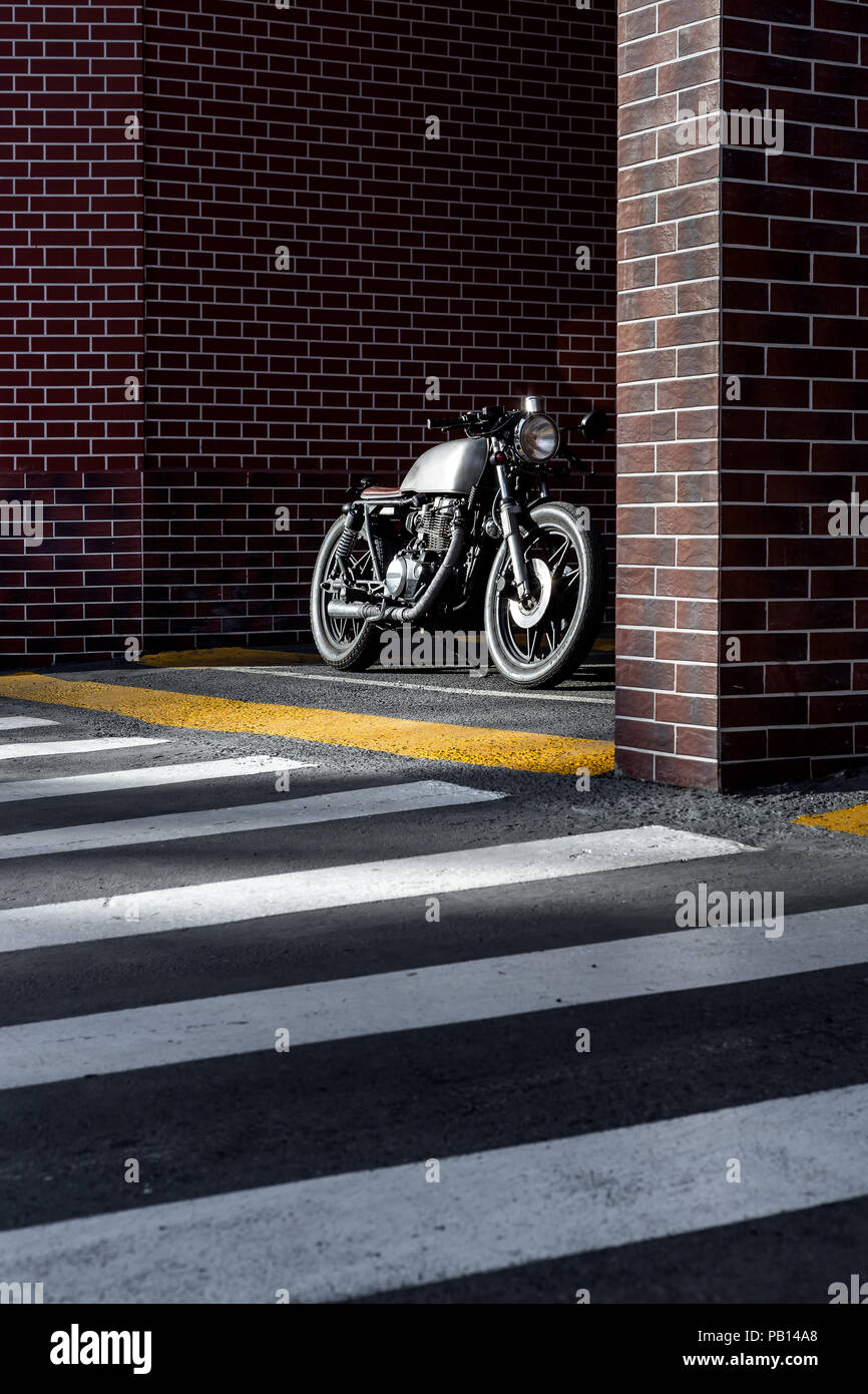Custom motorcycle parking near brick wall of finance building ...