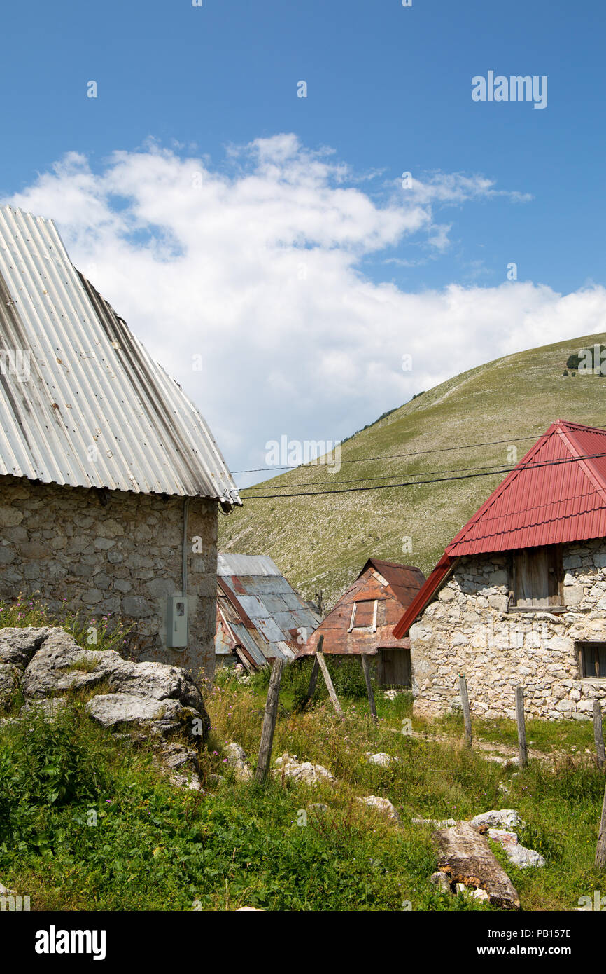 Stone built house and barns surrounded by weeds and grass in highest ...