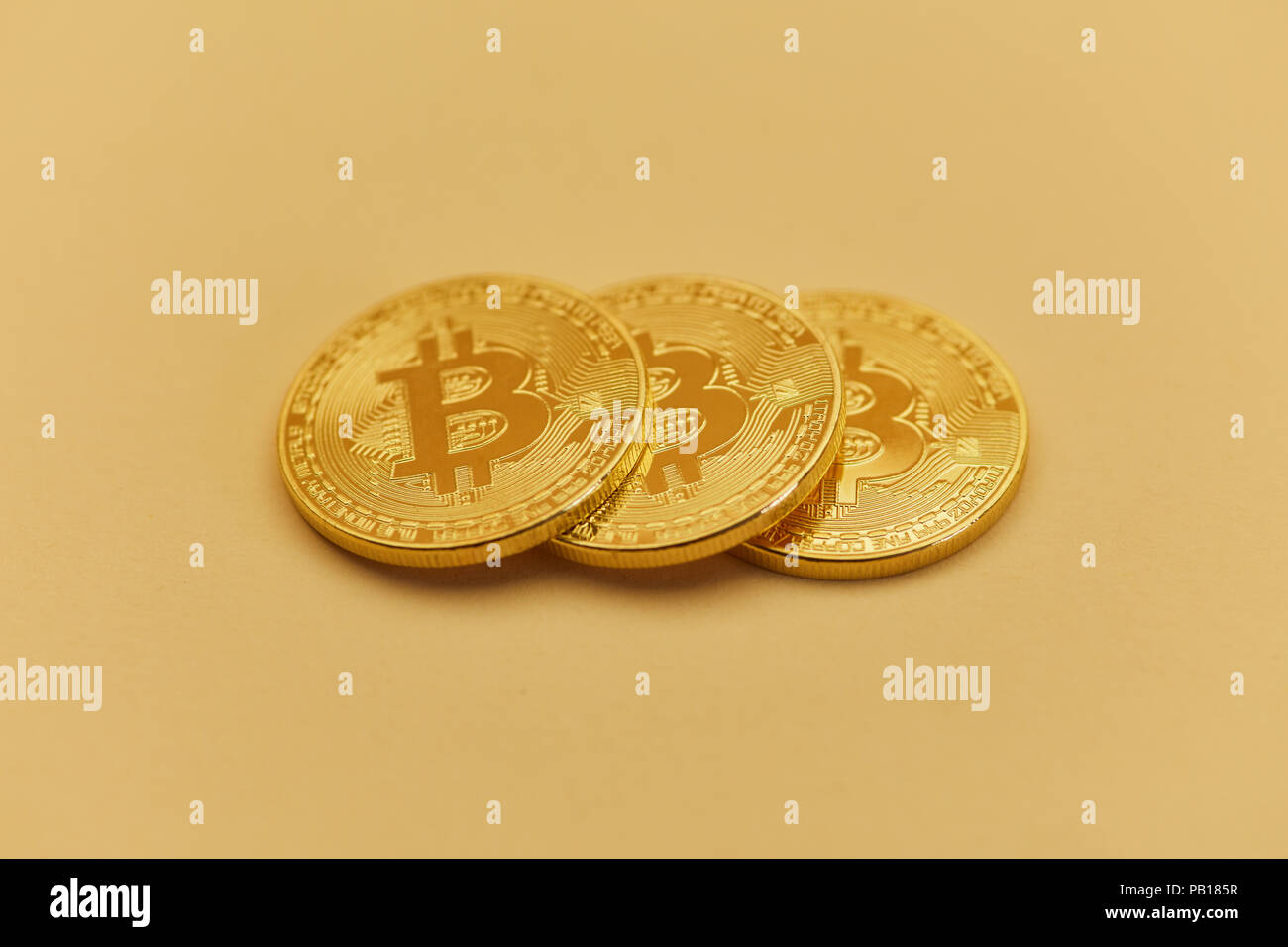 Bitcoin coins in front of a yellow background as a crypto currency ...