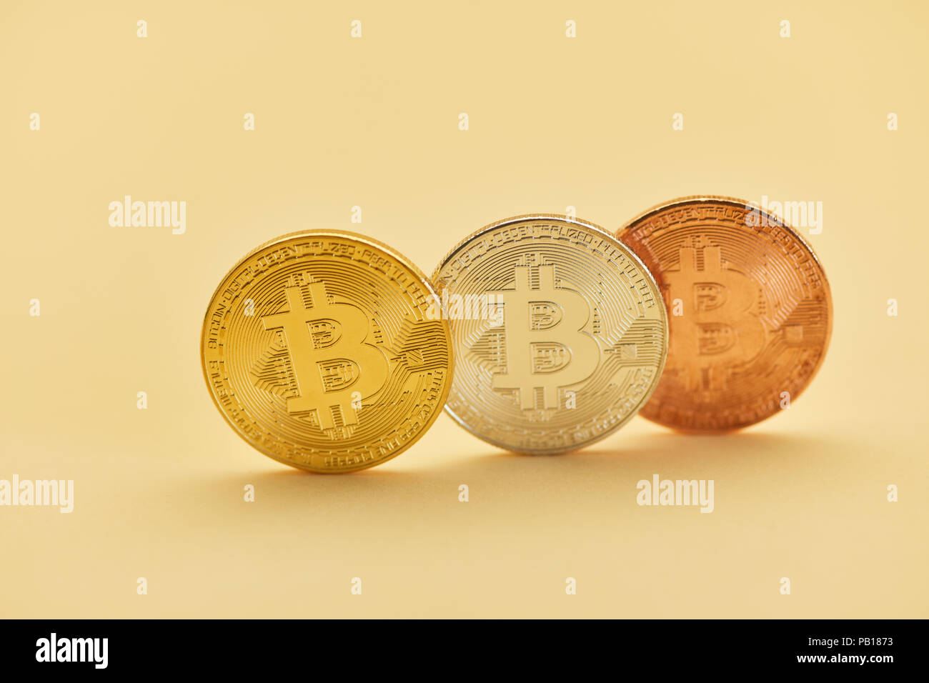 Three Bitcoin coins in gold silver bronze stand in a row Stock Photo ...