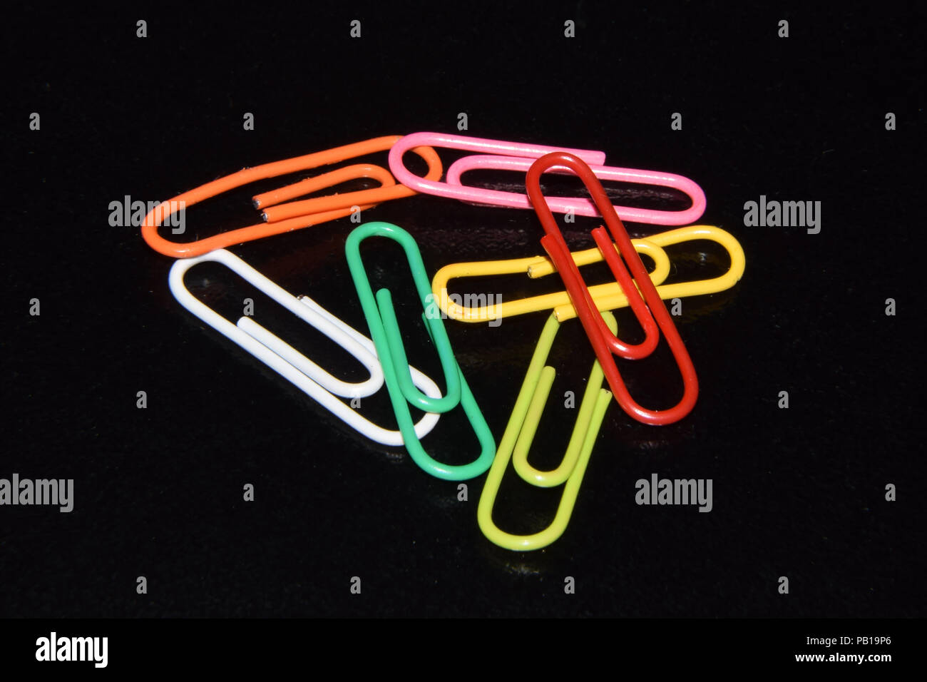 Heap of colorful paper clips - office tools, isolated work objects on ...
