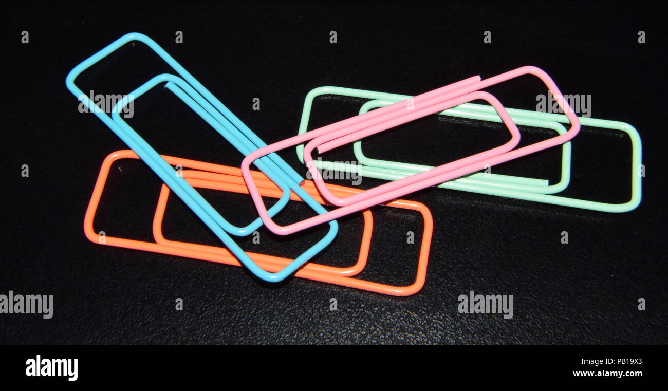 Heap of colorful paper clips - office tools, isolated work objects on ...