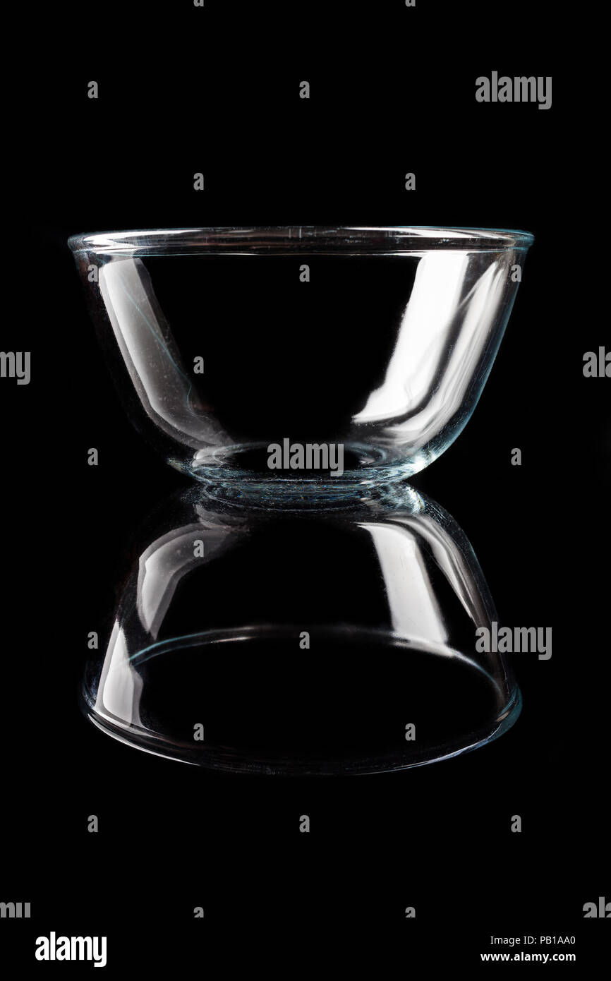 Glass transparent bowl on black background from side with reflection ...