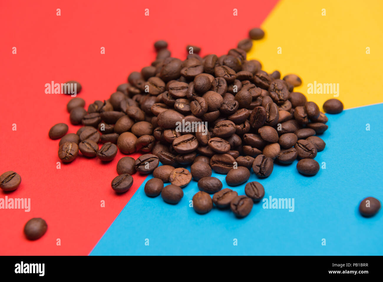 Coffee seeds on a colored background Stock Photo - Alamy