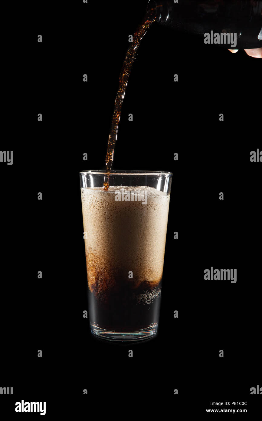 International Beer Day. Stout ale being poured in to a pint glass ...