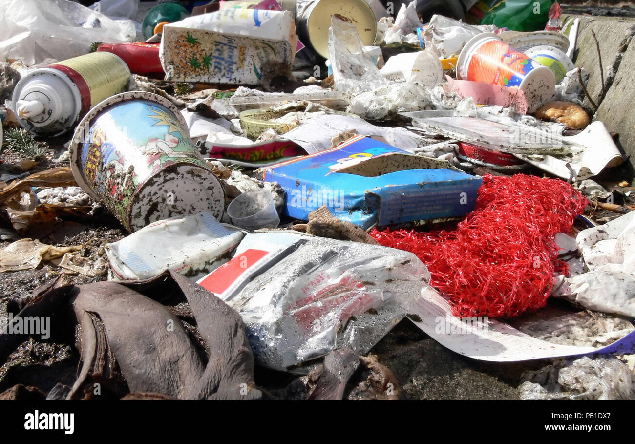 various garbage spread on the ground of the city Stock Photo - Alamy