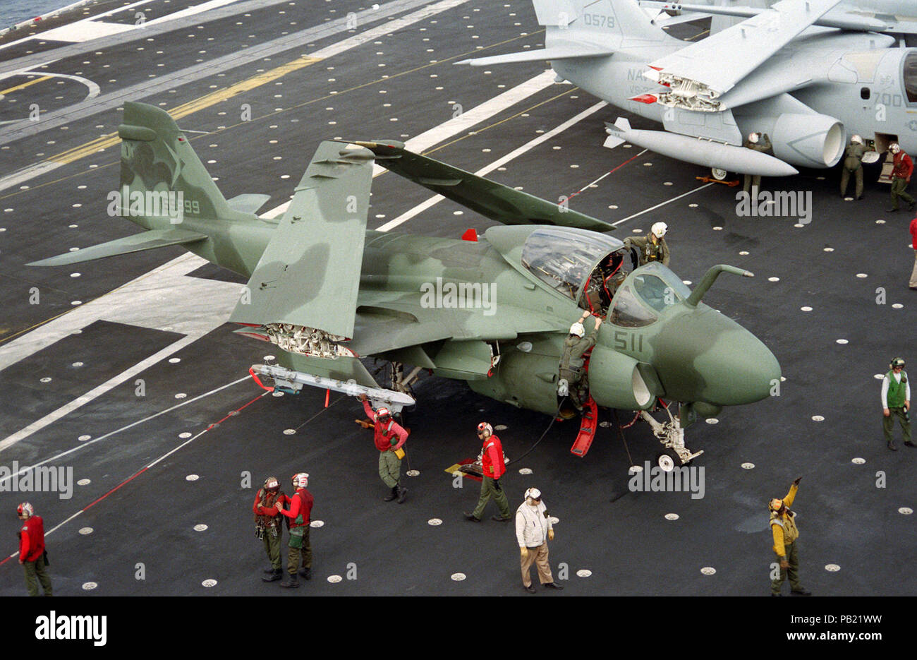 A-6E VA-165 in green paint on CV-64 1990. US Navy (USN) personnel prep ...