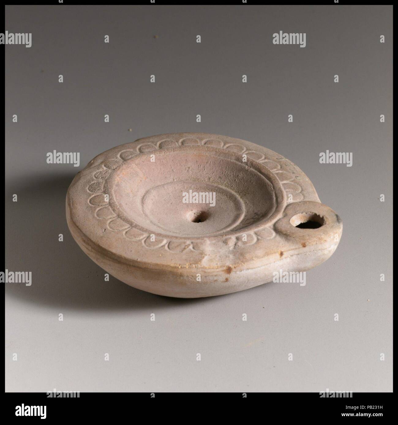 Lamp. Culture: Roman. Dimensions: Overall: 7/8 x 2 7/8 in. (2.2 x 7.3 ...