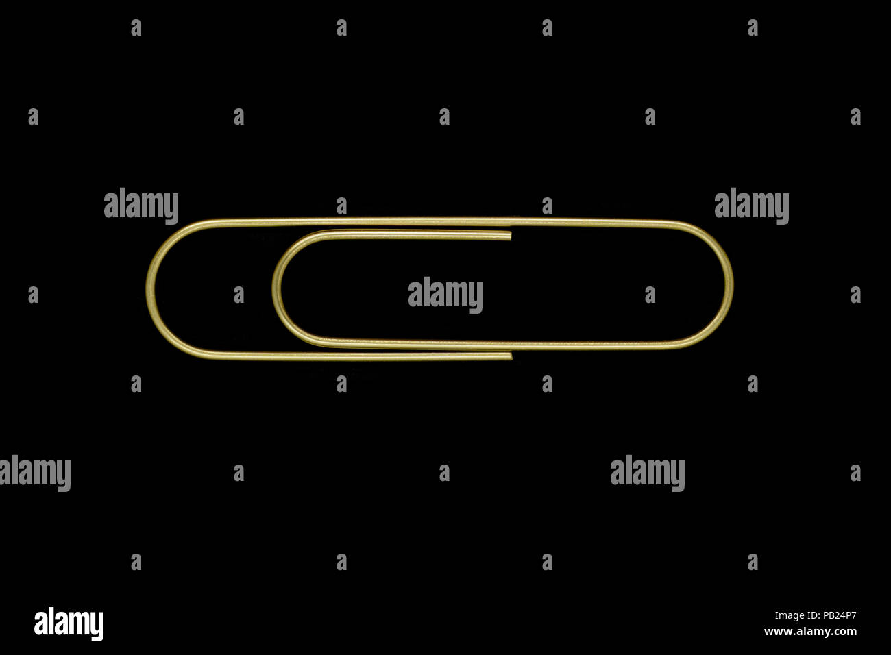 Sharp and clear view of isolated golden paperclip on black background ...