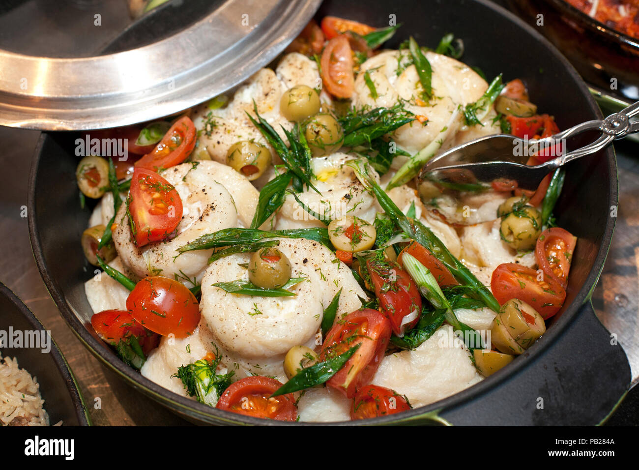 Mediterranean white fish meal in a pan with Stock Photo - Alamy