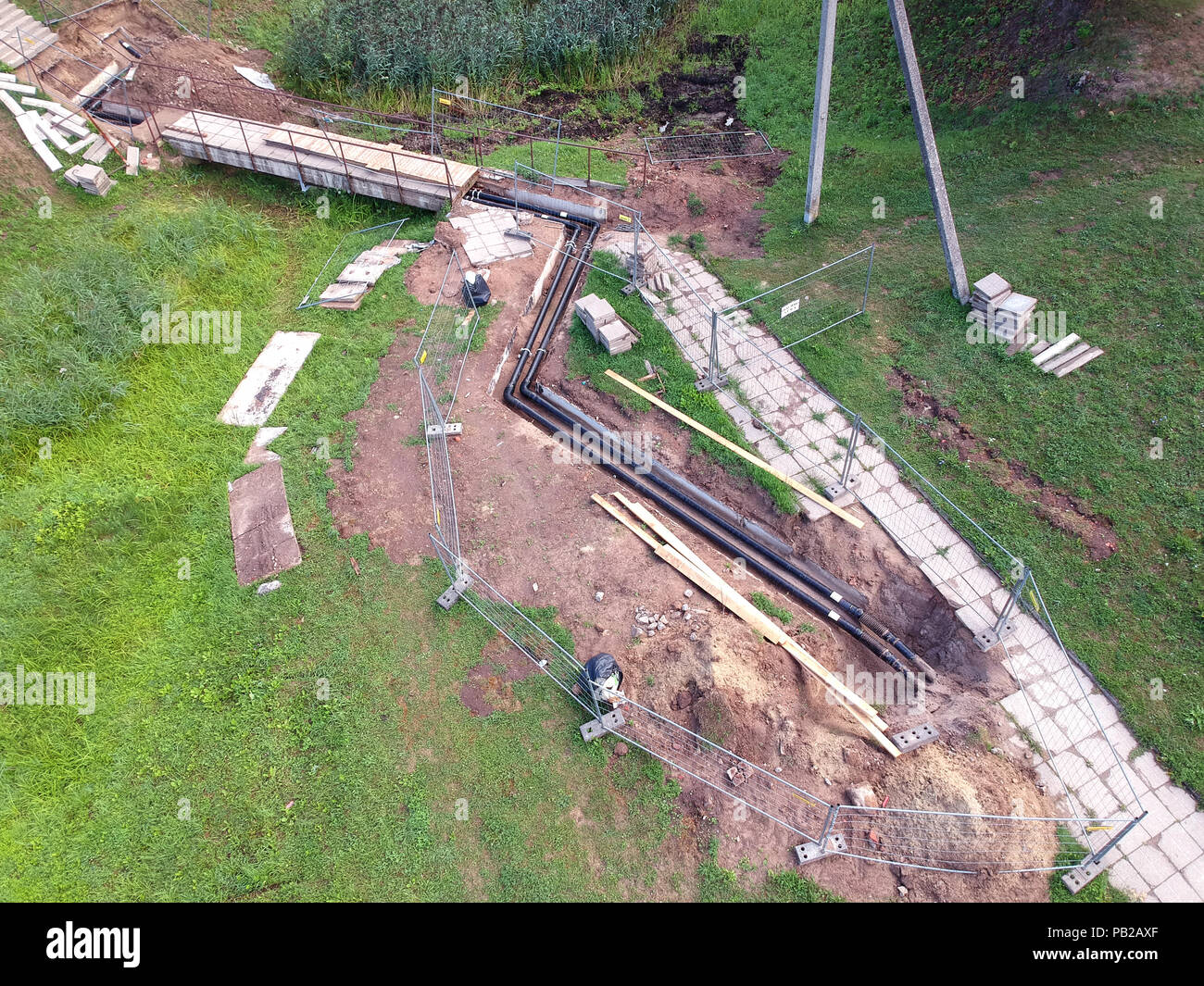 Trench and heating system pipeline in park from drone, aerial view ...