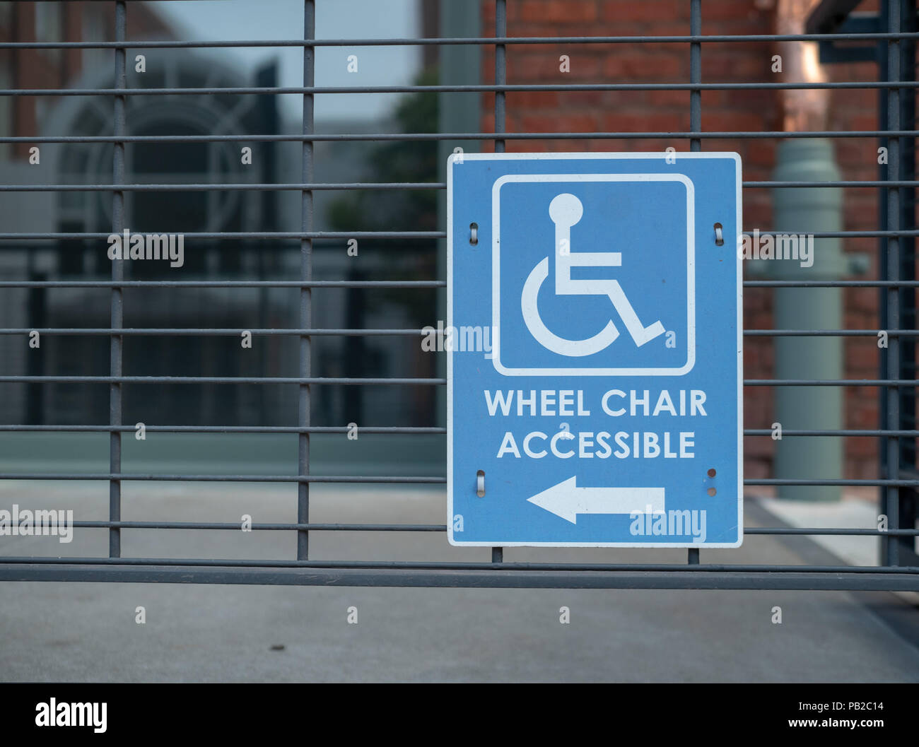 Handicap sign, wheel chair accessible logo pointing to left outdoor ...