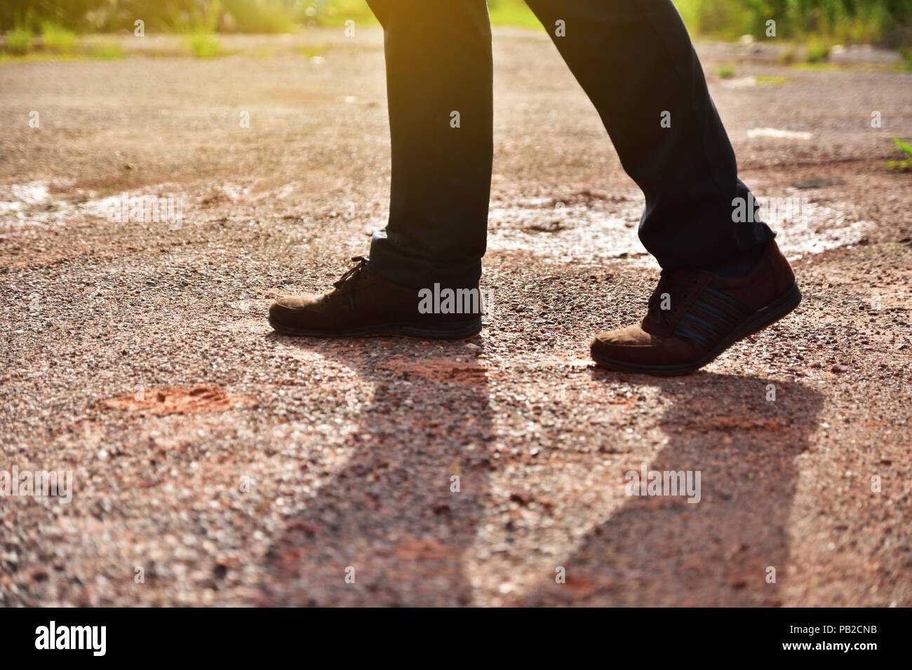 Man walking on street sunlight background Stock Photo - Alamy