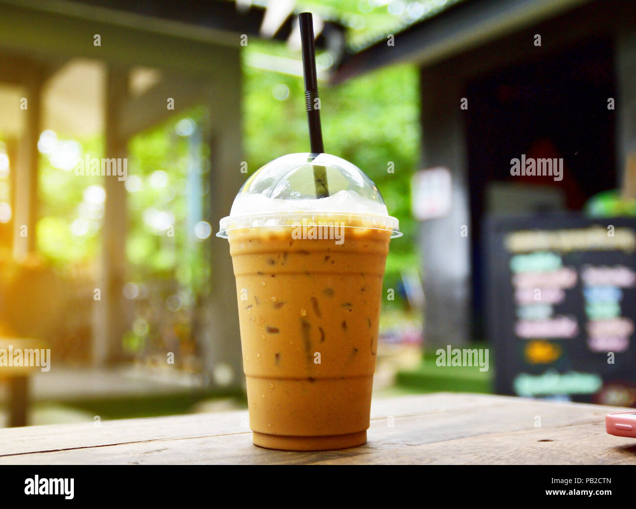 Ice coffee on wooden table in coffee shop for drink Stock Photo - Alamy