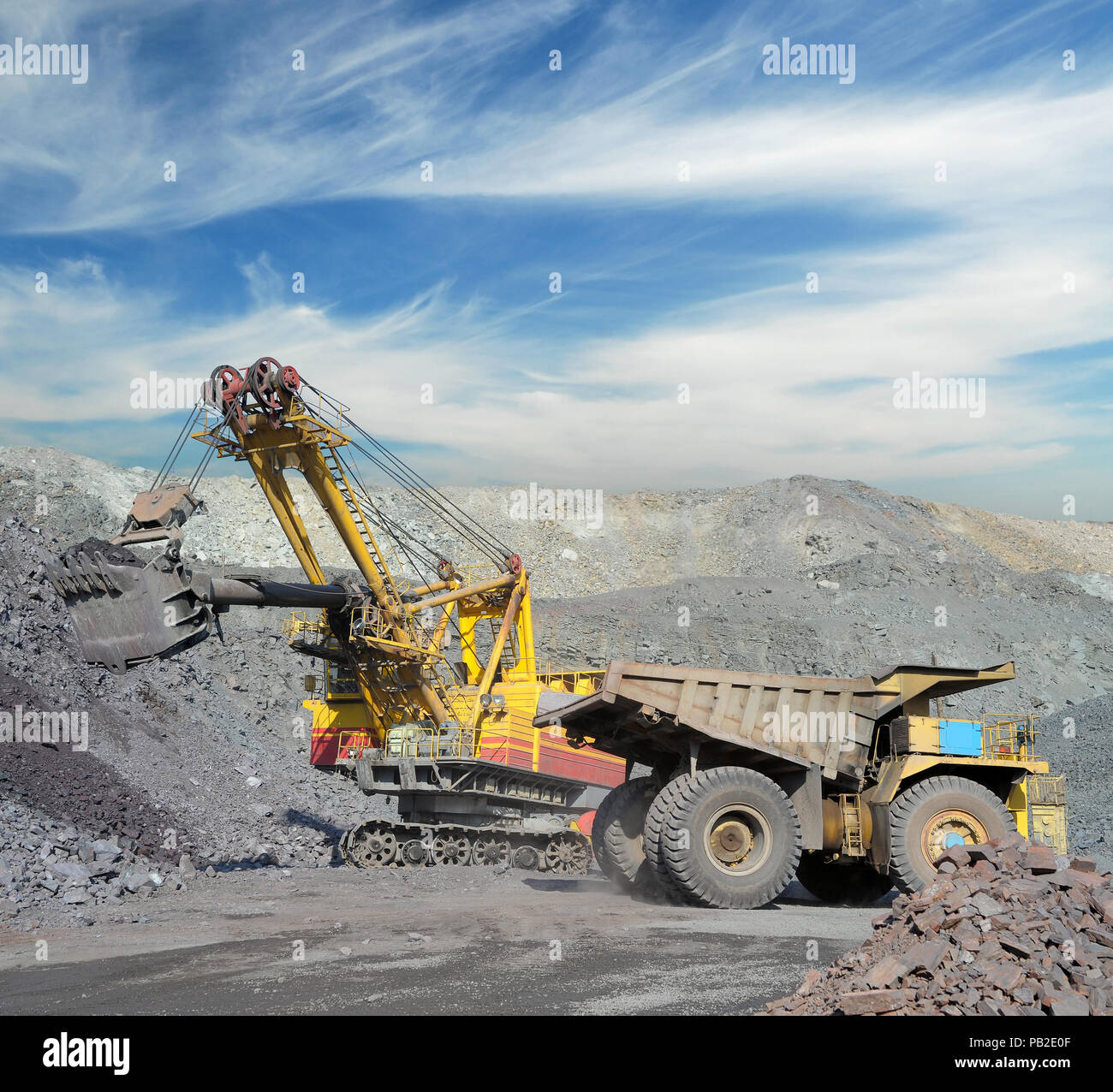 Loading of iron ore on very big dump-body truck Stock Photo - Alamy