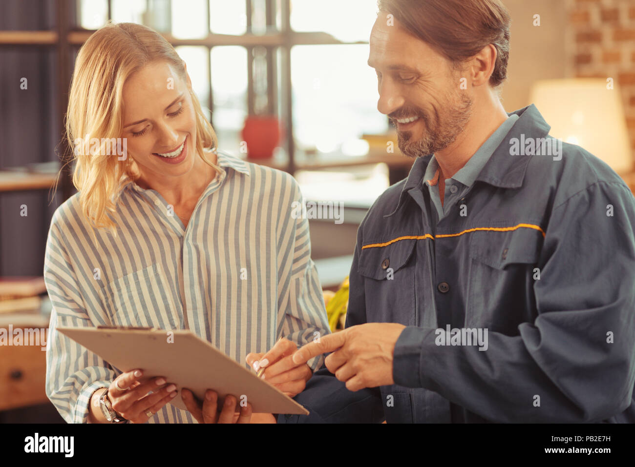 Attentive female person putting her sign Stock Photo - Alamy