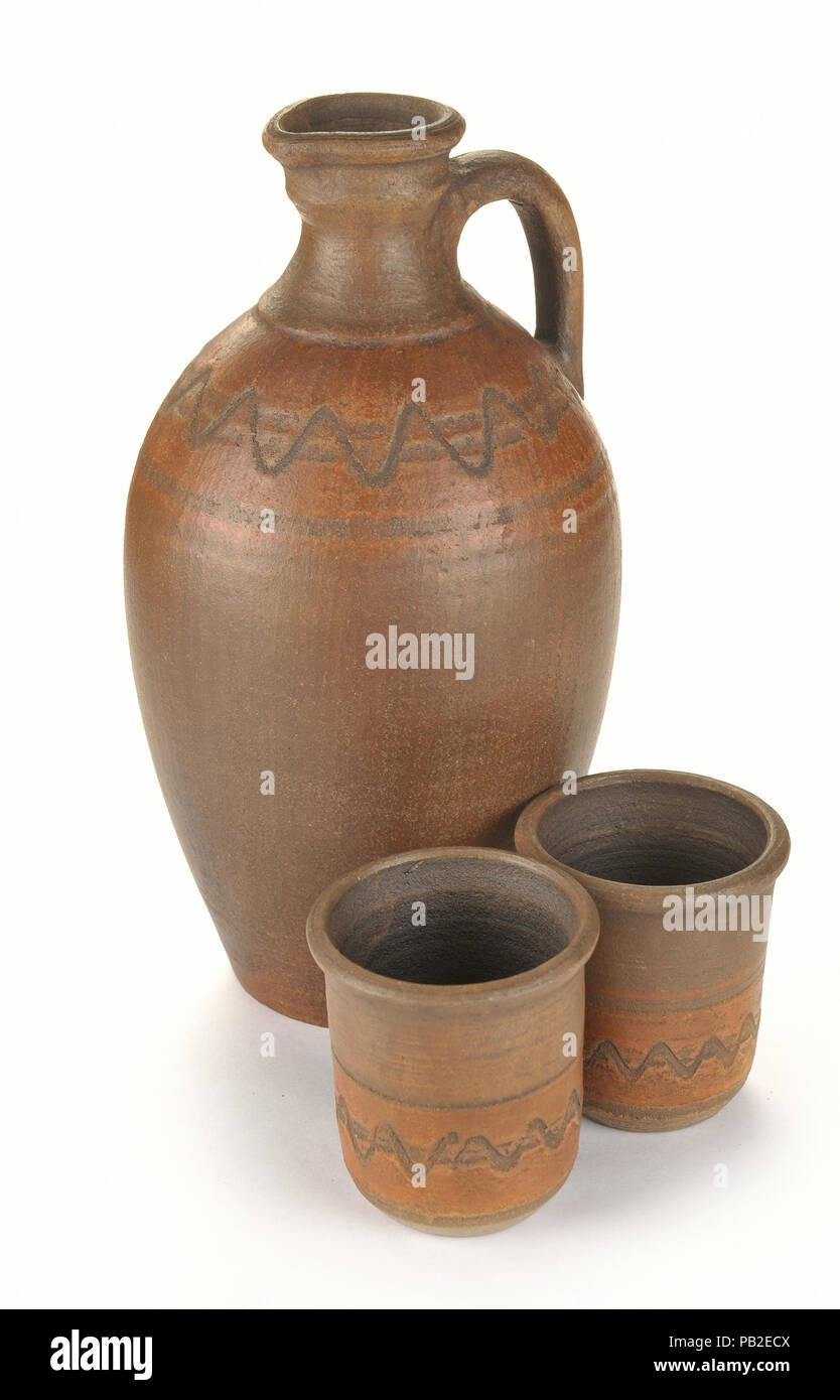 pitcher and two cups of clay on a white Stock Photo - Alamy