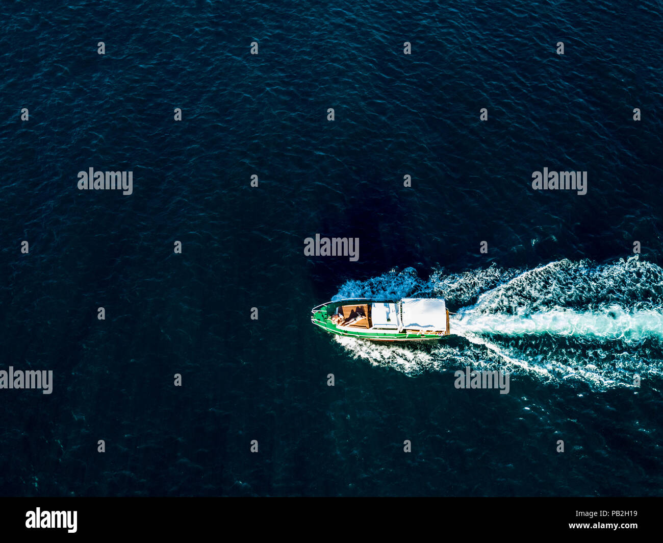 top view of fast travel boat going straight forward in the sea aerial ...