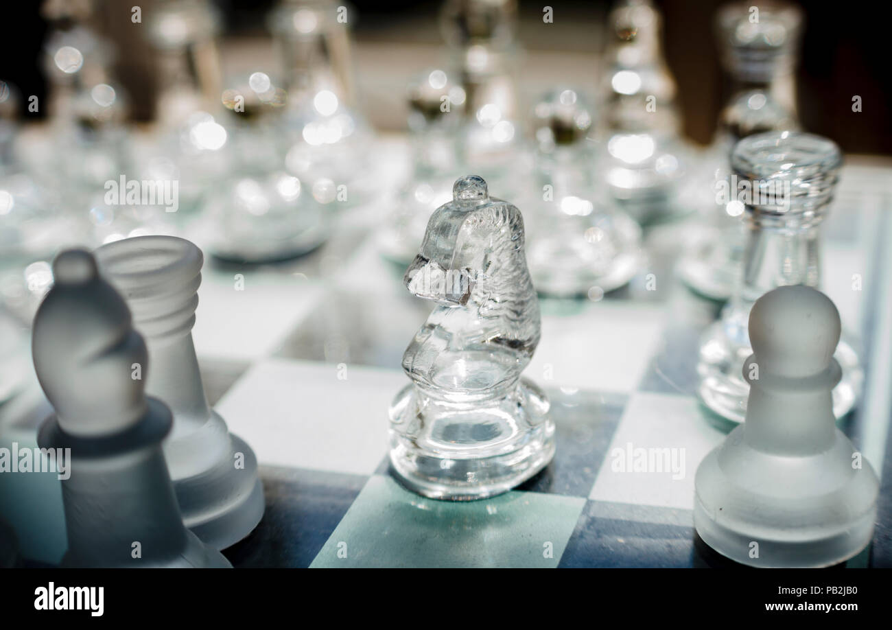 Glass chess pieces on a glass chessboard Stock Photo - Alamy