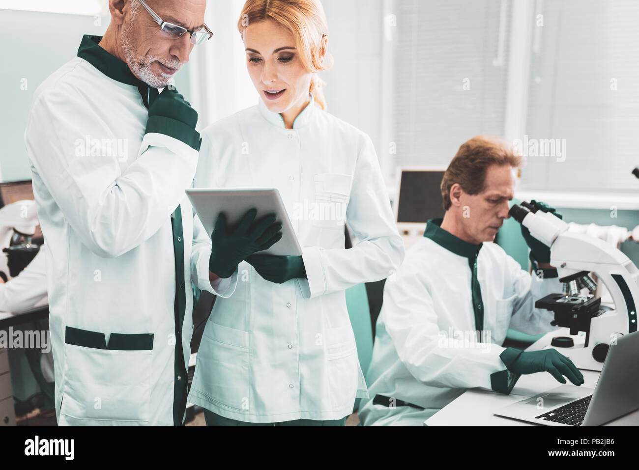 Intelligent biologists studying mutation process Stock Photo - Alamy