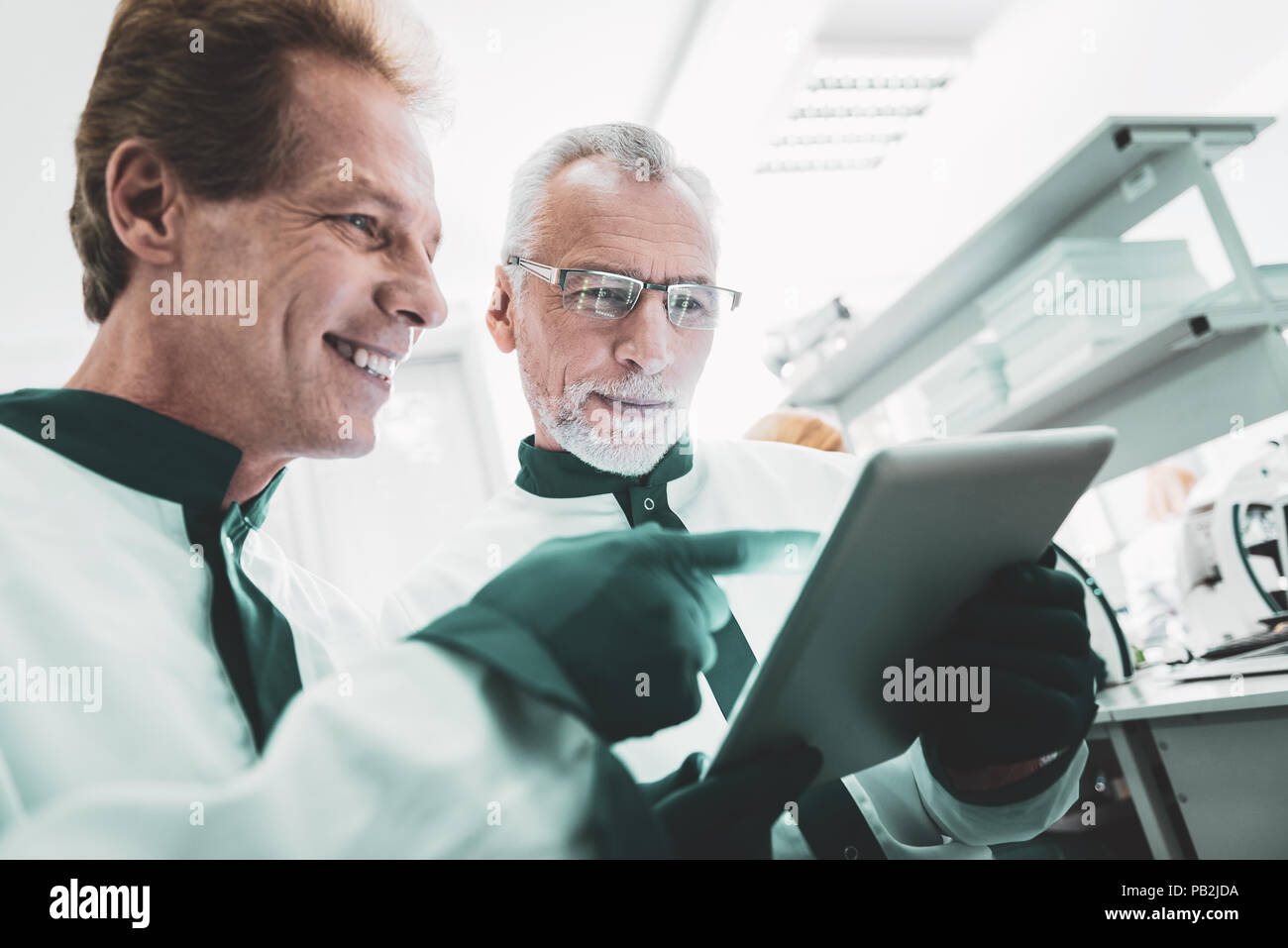 Two modern scientists standing near professional equipment Stock Photo ...