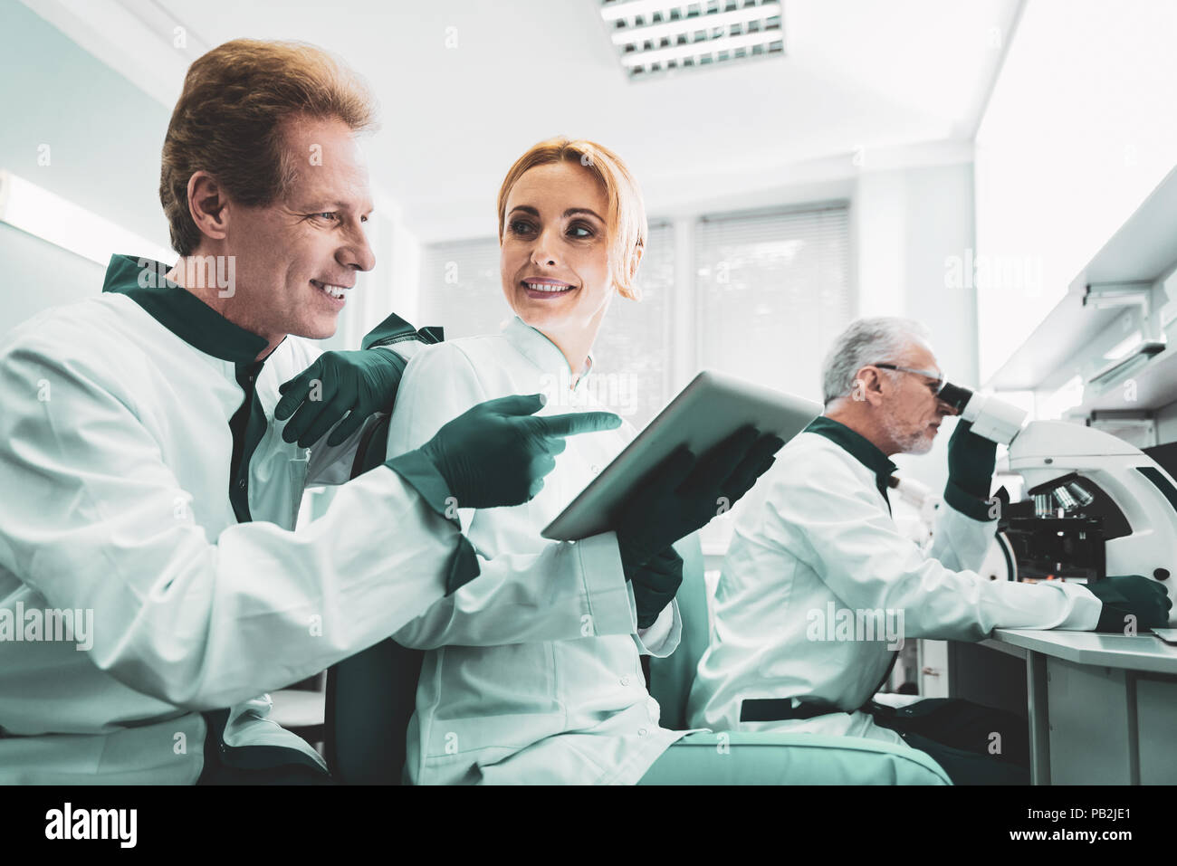 Professional technical engineer telling some news to his partner Stock ...
