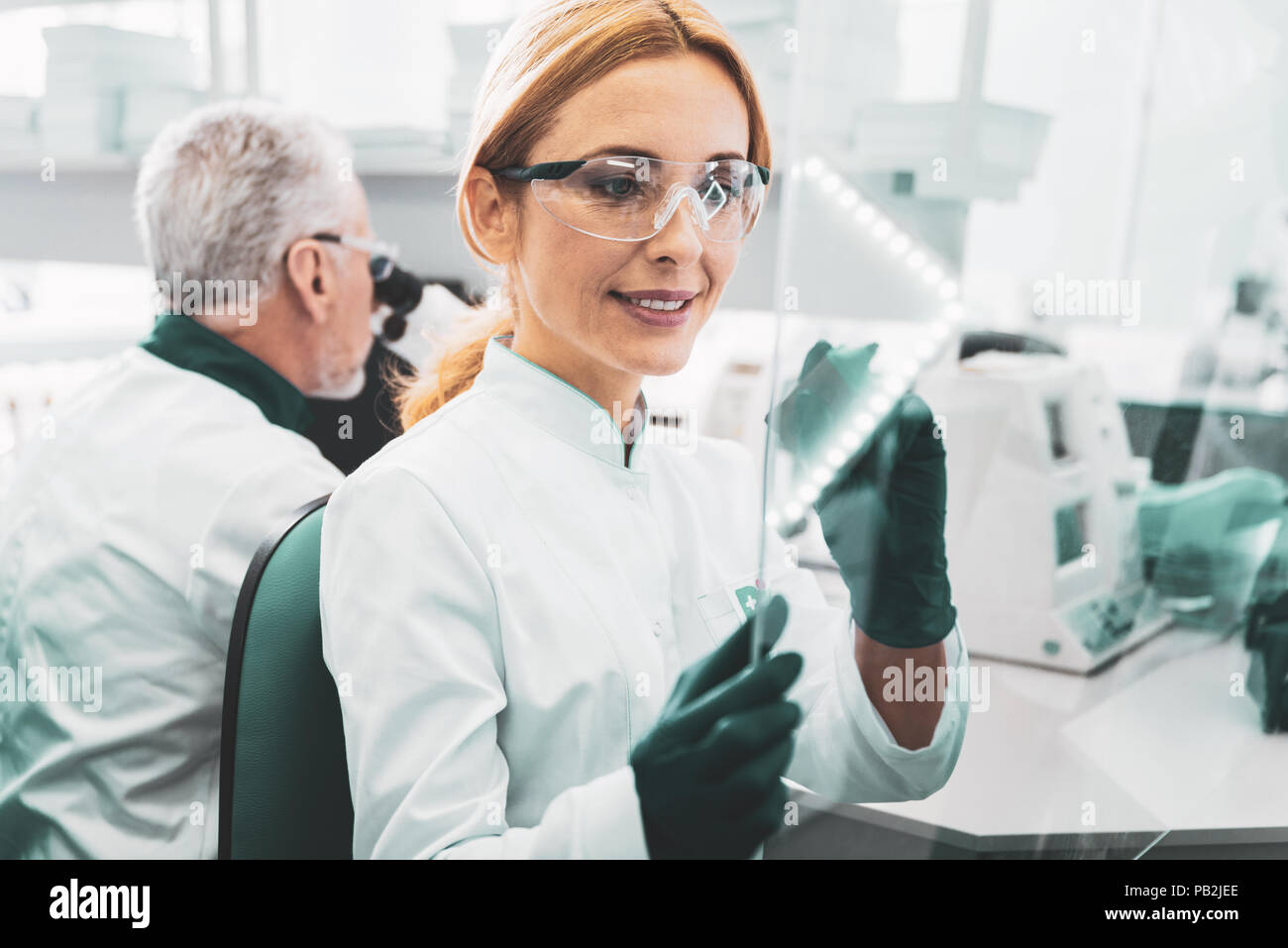 Female chemist wearing glasses writing molecular formula Stock Photo ...