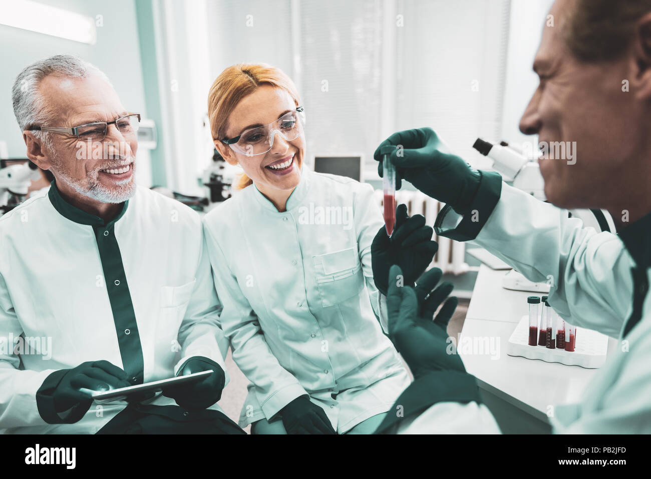 Trio of smiling medical workers enjoying completing task Stock Photo ...