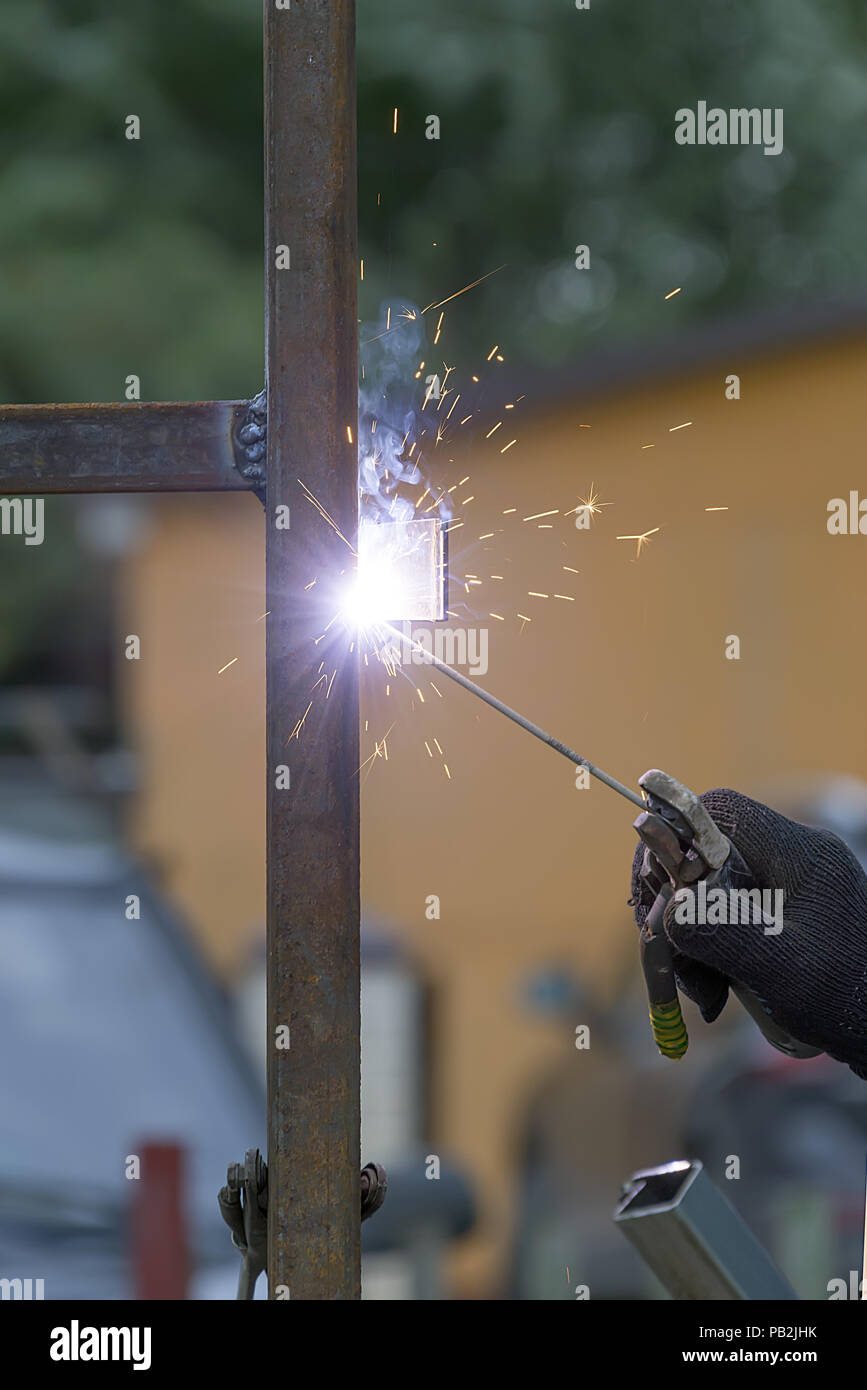 a welder who works welds iron Stock Photo - Alamy