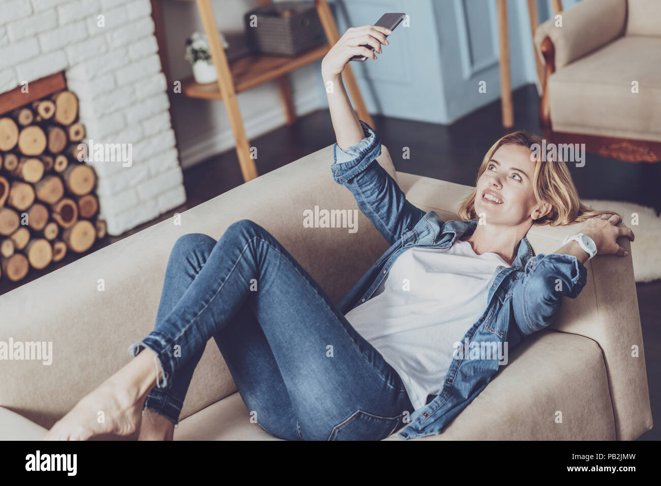 Relaxed female person lying on cozy couch Stock Photo - Alamy