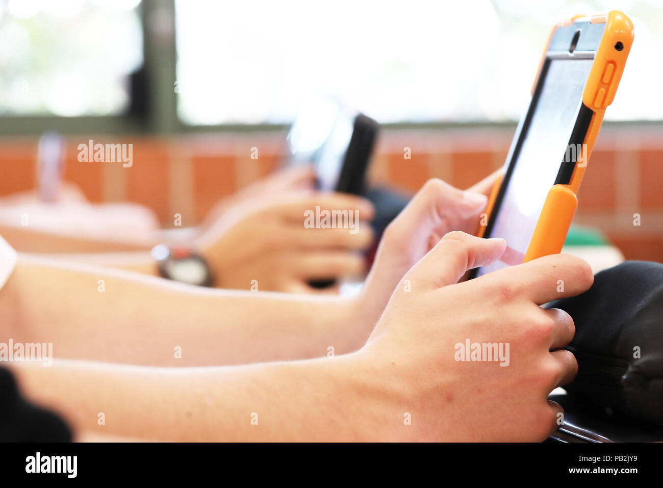 High school students working on using an ipad tablet style electronic ...