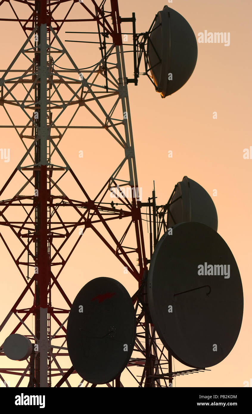 Several parabolic antennas, first rays of the morning sun Stock Photo ...