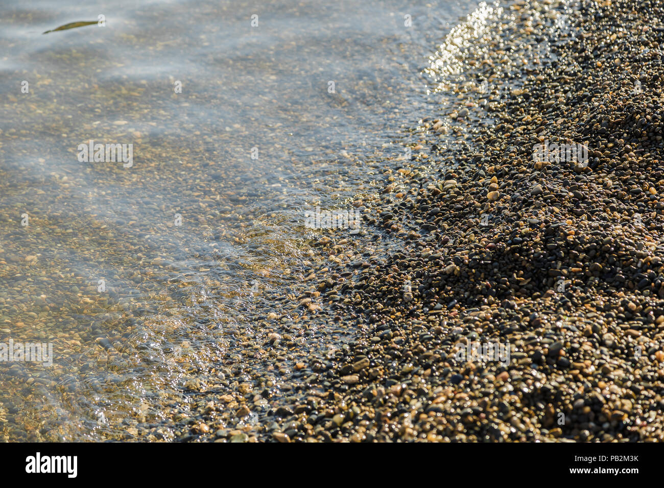 pebbles on the beach pebbles on the sea shore and waves of water ...