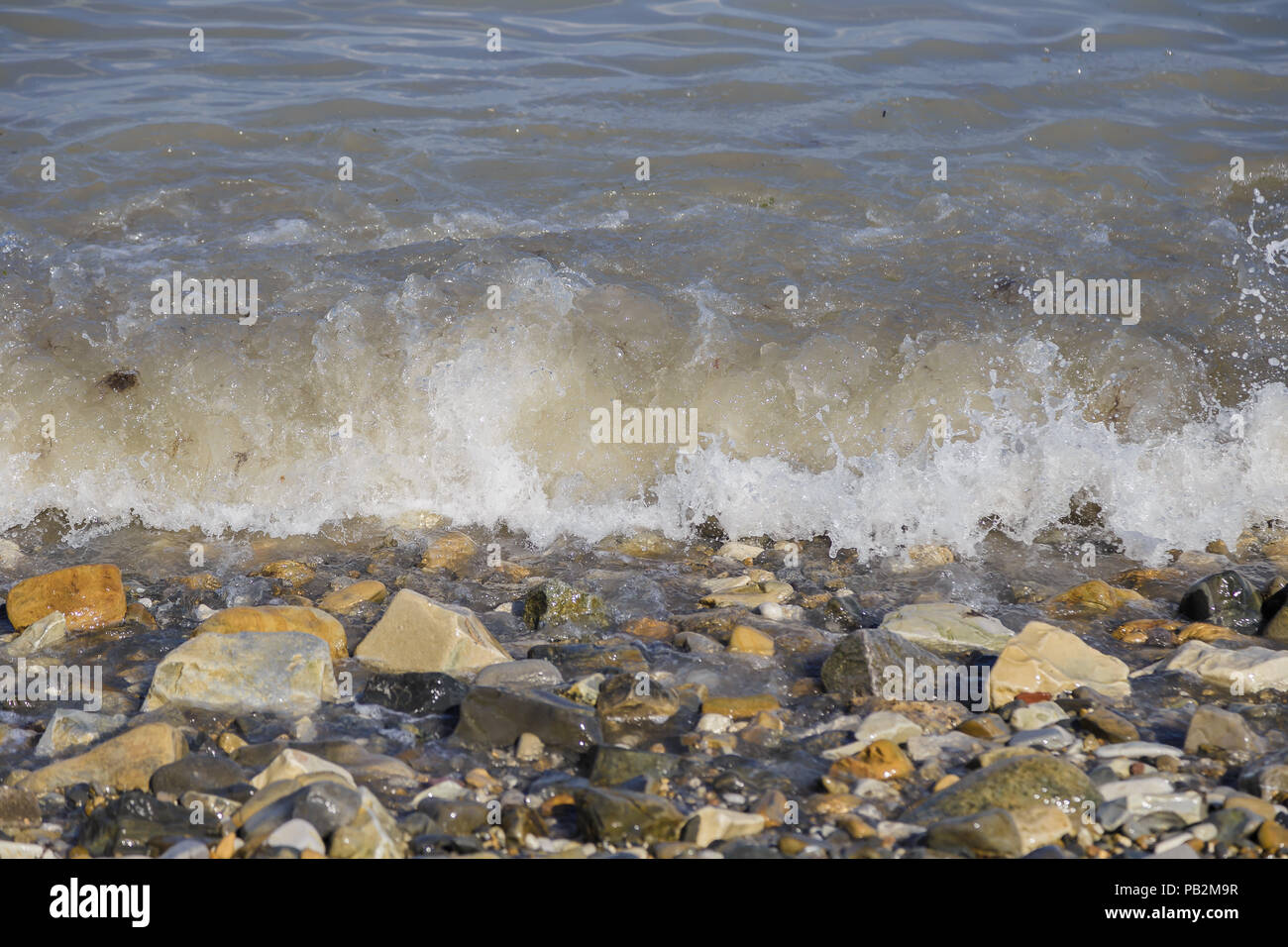 pebbles on the beach pebbles on the sea shore and waves of water ...