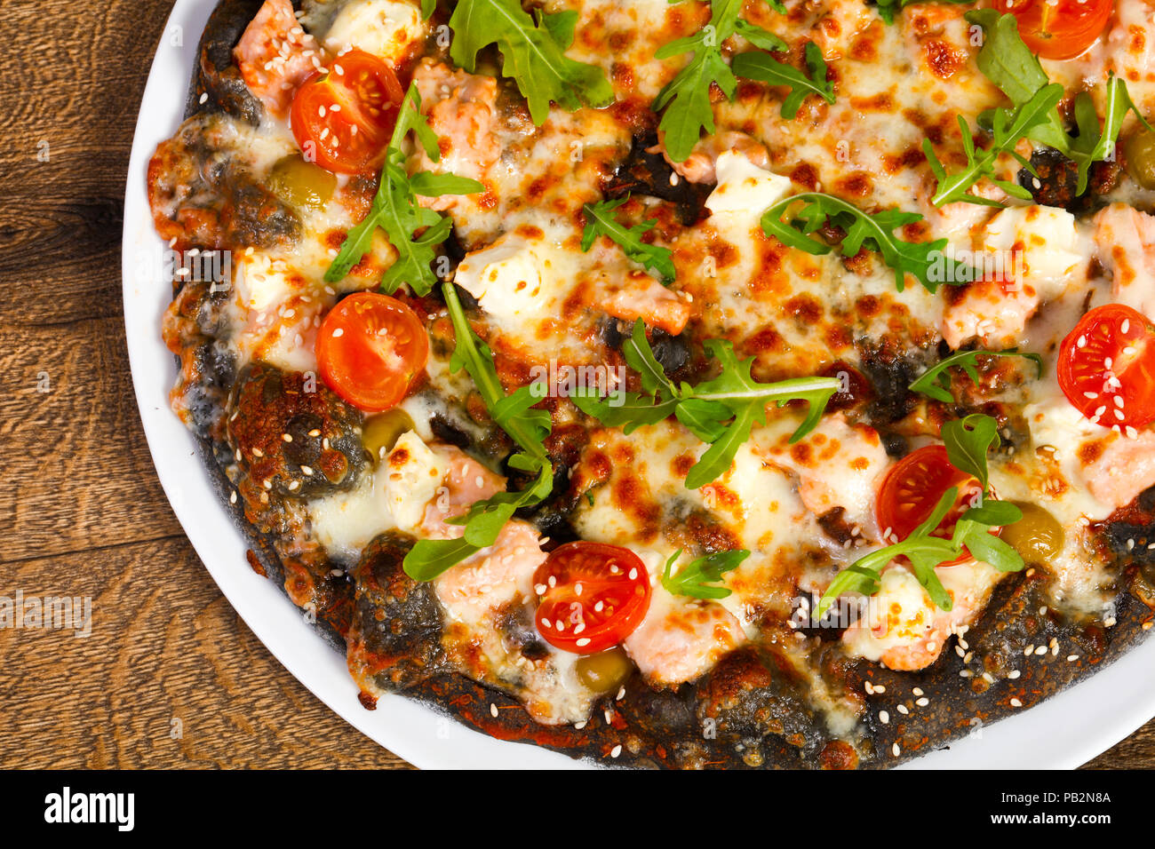 Pizza with salmon and mozzarella with ruccola Stock Photo - Alamy