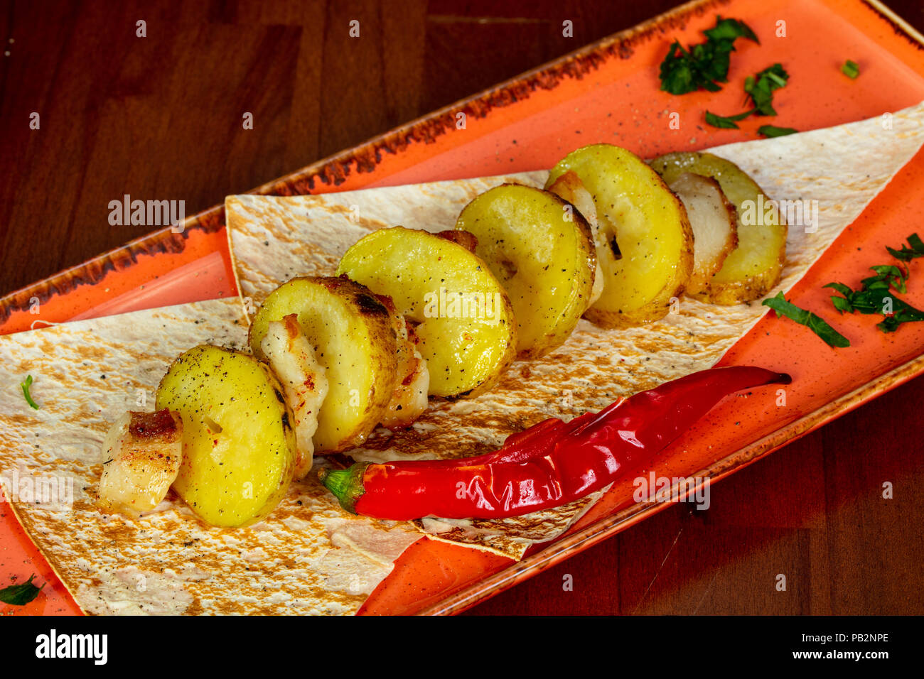 Grilled potato bbq with fat meat Stock Photo - Alamy