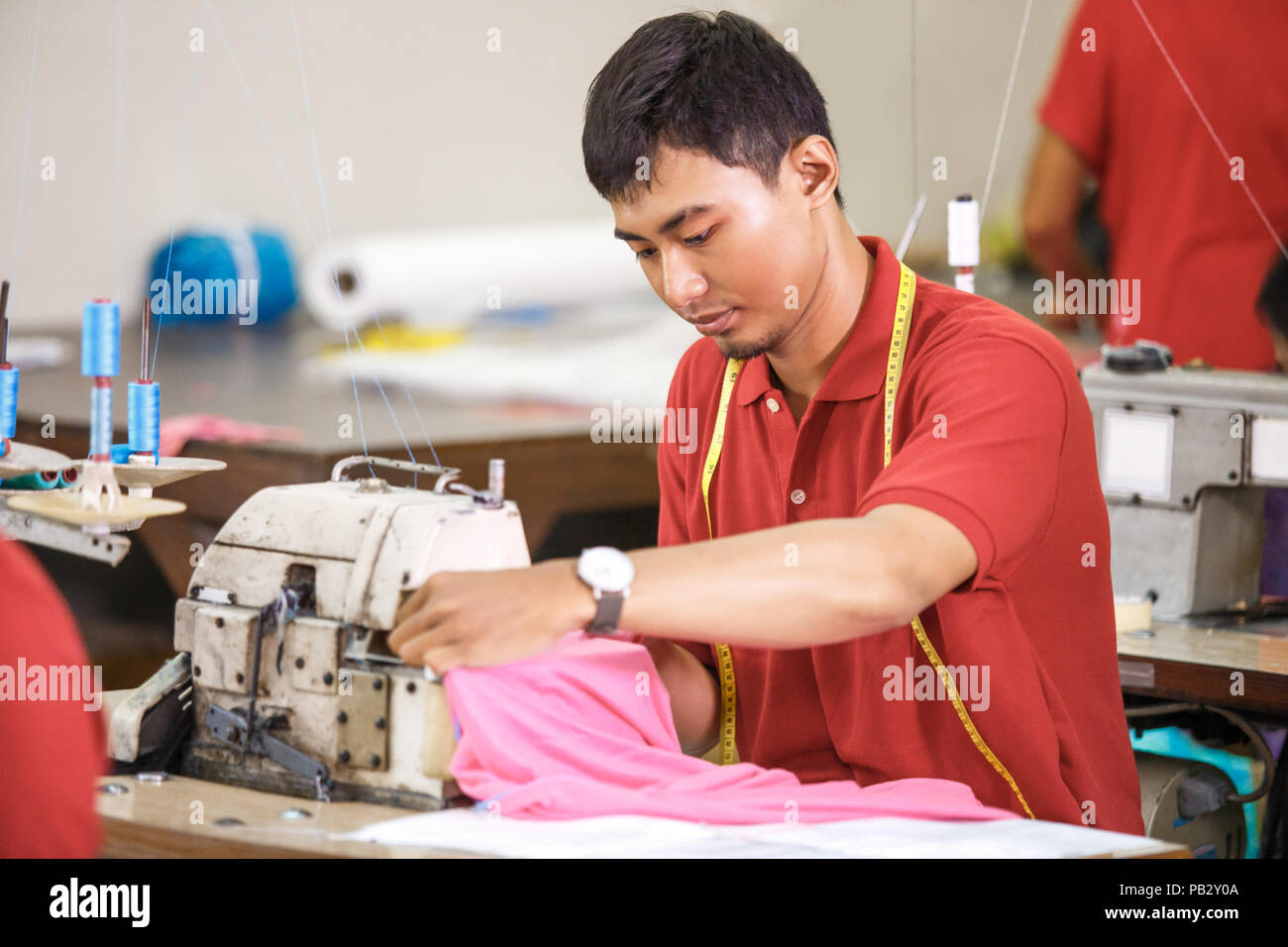 asian worker in textile factory sewing using industrial sewing m Stock ...