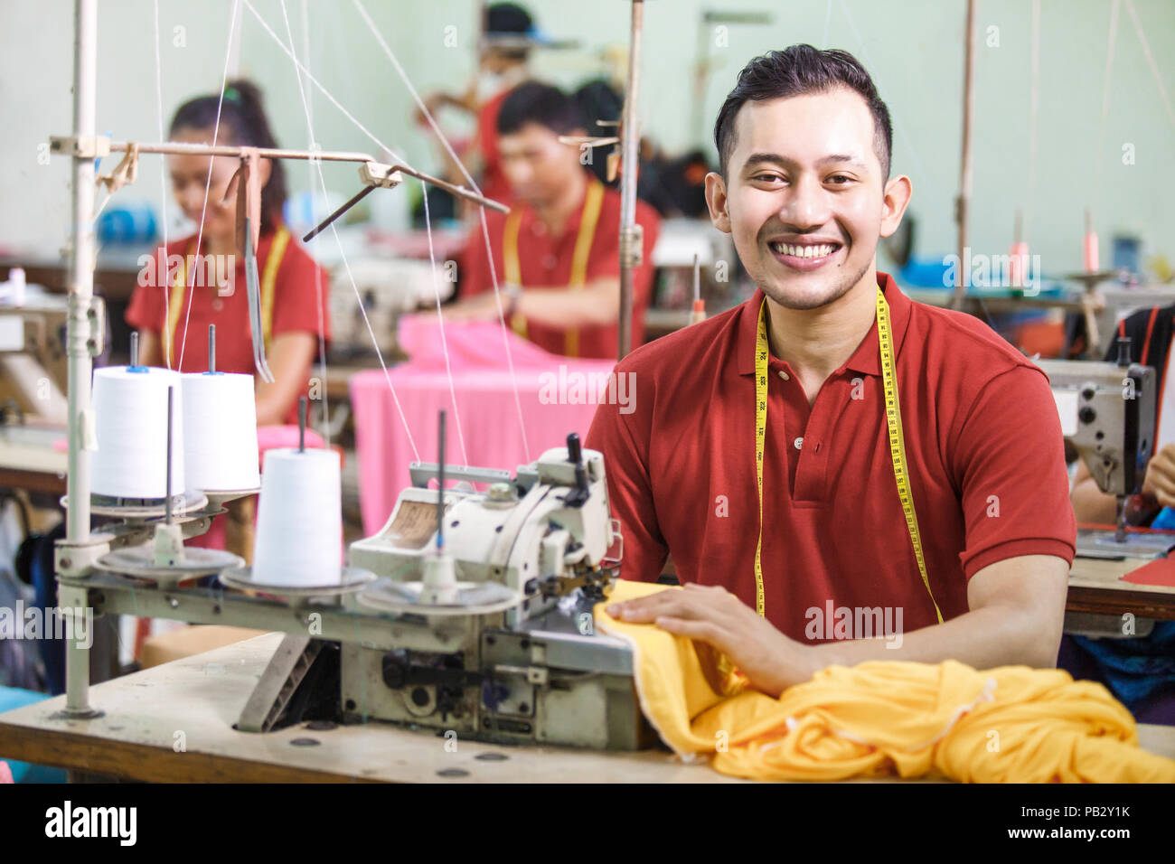asian worker in textile factory sewing using industrial sewing m Stock ...