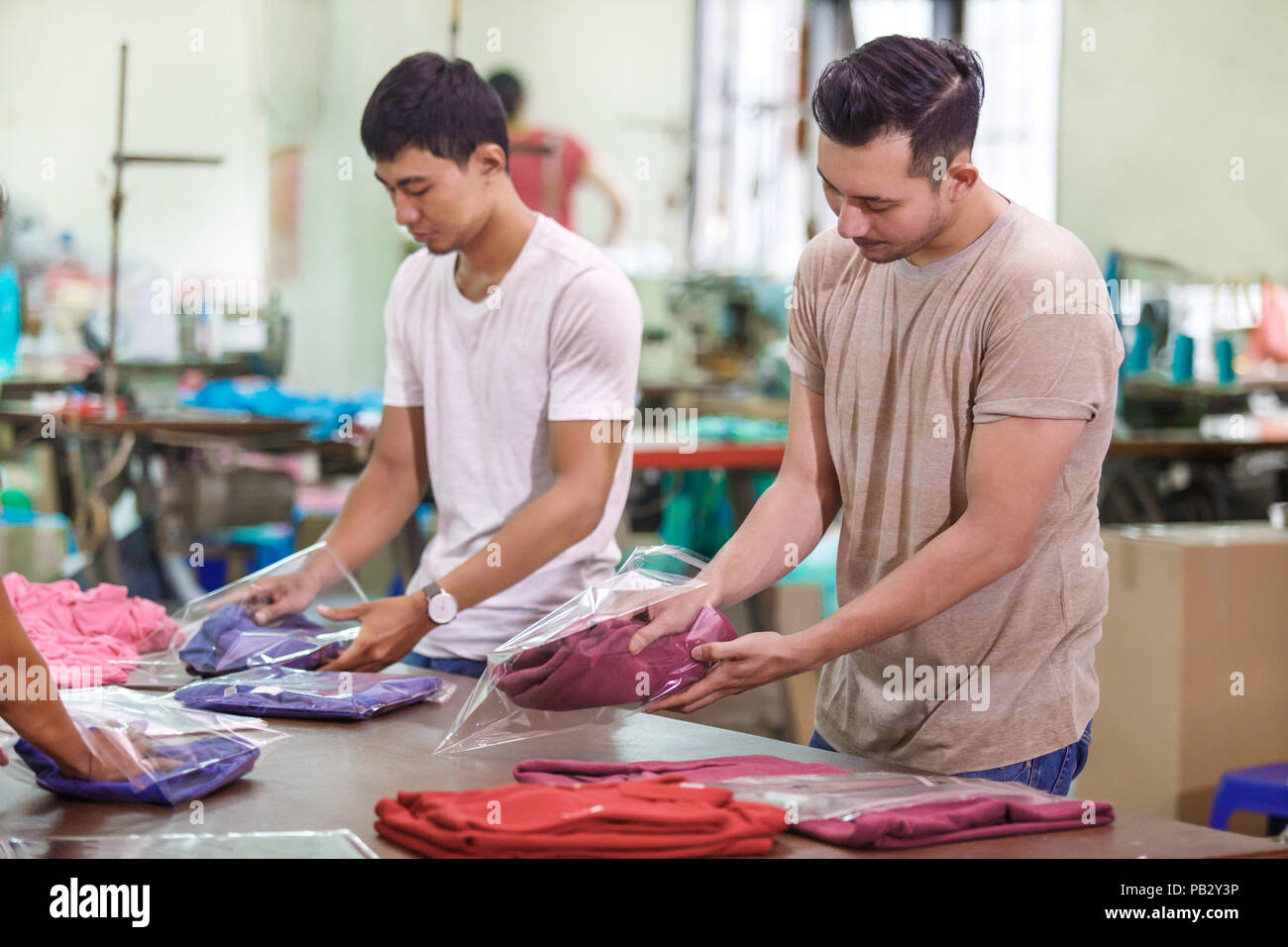 employees in textile factory packaging their products Stock Photo - Alamy