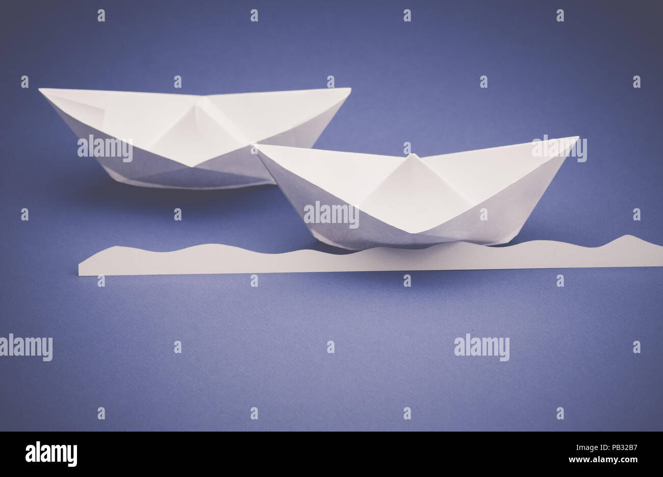 white paper origami sailing boat on a blue sea Stock Photo - Alamy