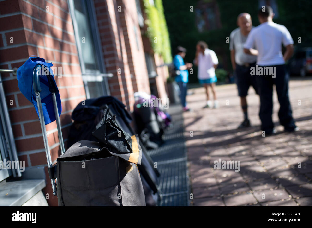 Munich, Germany. 26th July, 2018. Homeless people stand with their ...