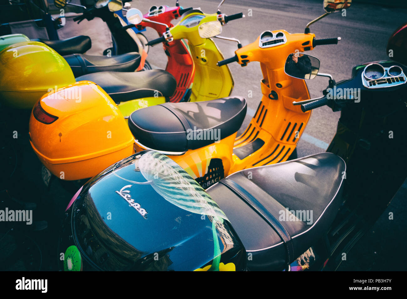 Wallpaper background of colourful Vespa scooters parked on the street ...