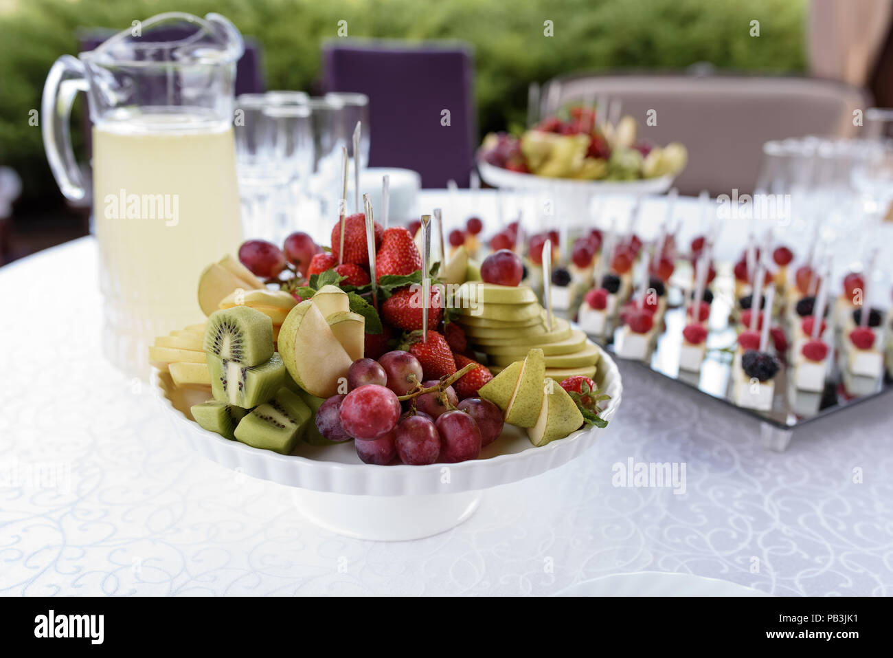 White fruit-pot with the range of bright fruit. Bright fruit on a ...